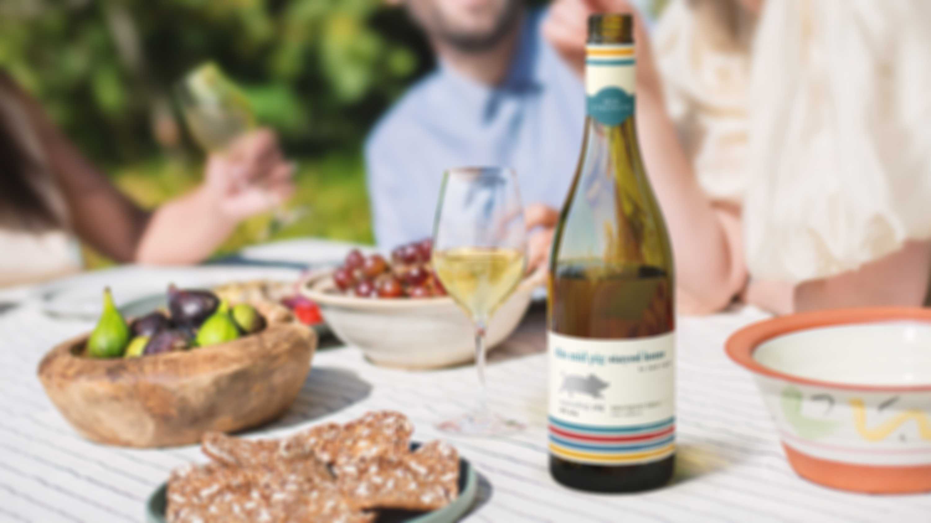 A bottle of Squealing Pig mid strength wine next to a glass and some ...